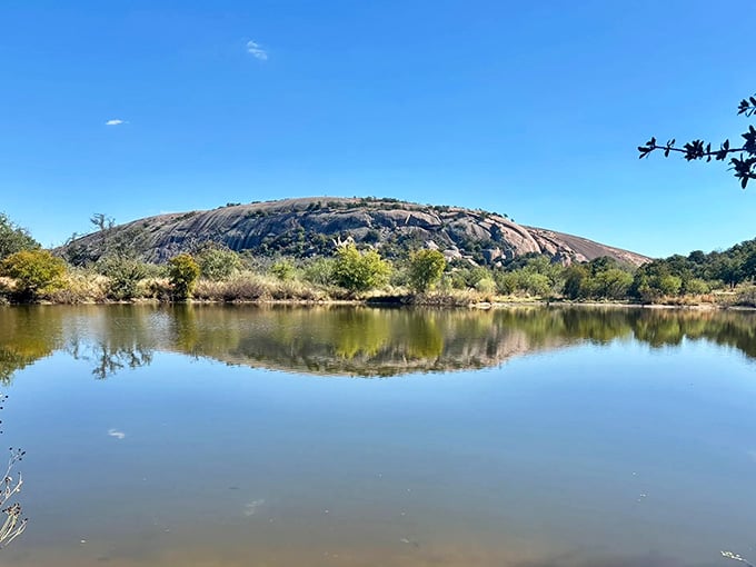 Moss Lake reflects Enchanted Rock like nature's own mirror, creating a postcard moment that'll make your friends question their vacation choices.