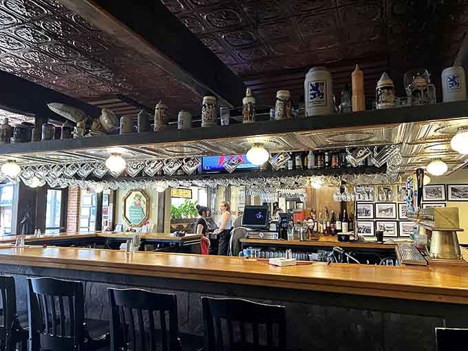 The bar gleams with promise, its ornate tin ceiling and beer stein collection telling stories of Bavarian tradition.