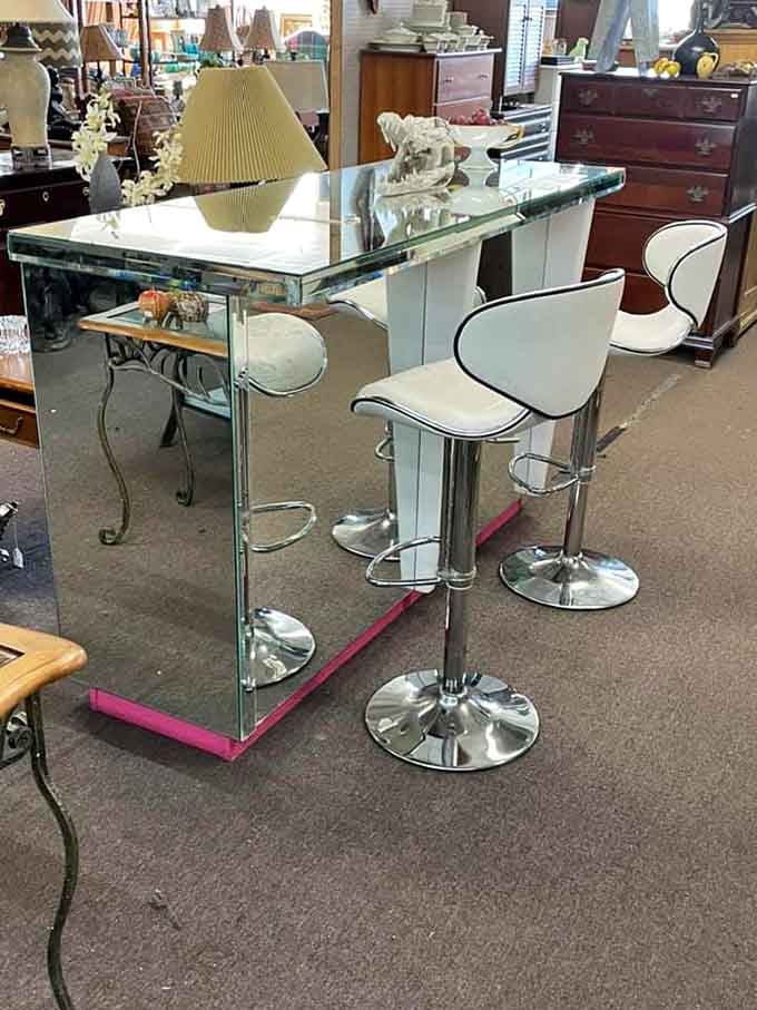 Chrome and glass meet modern design in this sleek bar setup that screams sophisticated entertaining.
