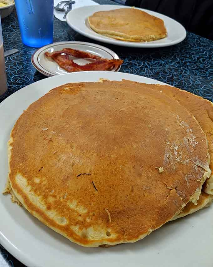 Pancakes so massive they overlap the plate edges, proving that bigger really is better in diner mathematics.
