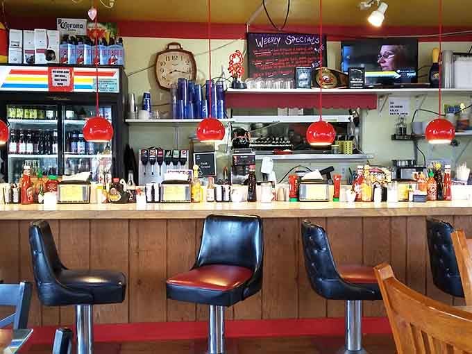 Red pendant lights and swivel stools create the perfect stage for morning coffee rituals and burger-induced food comas alike.