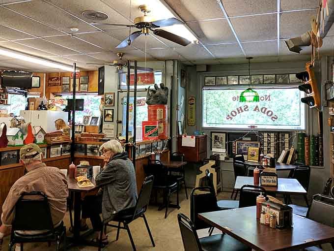 Diners enjoying their meals surrounded by decades of collected Americana, because multitasking between eating and museum-browsing is efficient.