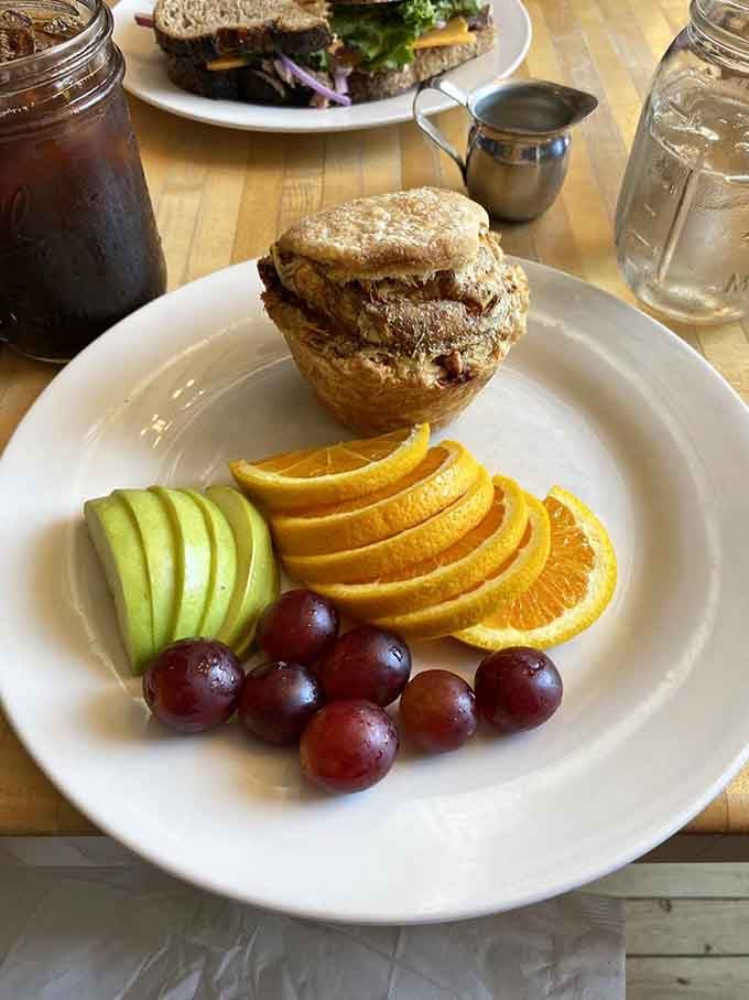 Quiche served with fresh fruit that's almost too pretty to eat, but your taste buds won't let you admire it for long.