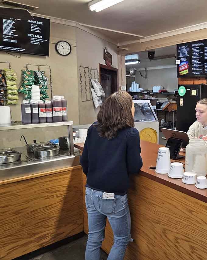 The ordering counter where decisions get made and anticipation builds while watching the kitchen work its smoky magic.