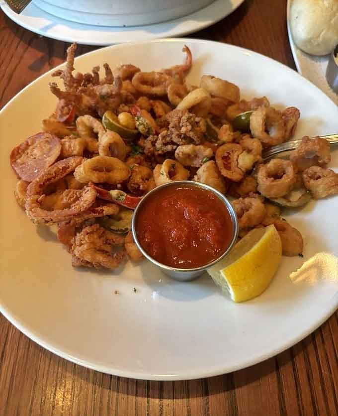 Golden fried calamari piled high with peppers, crispy and tender, disappearing faster than you can say "more please."