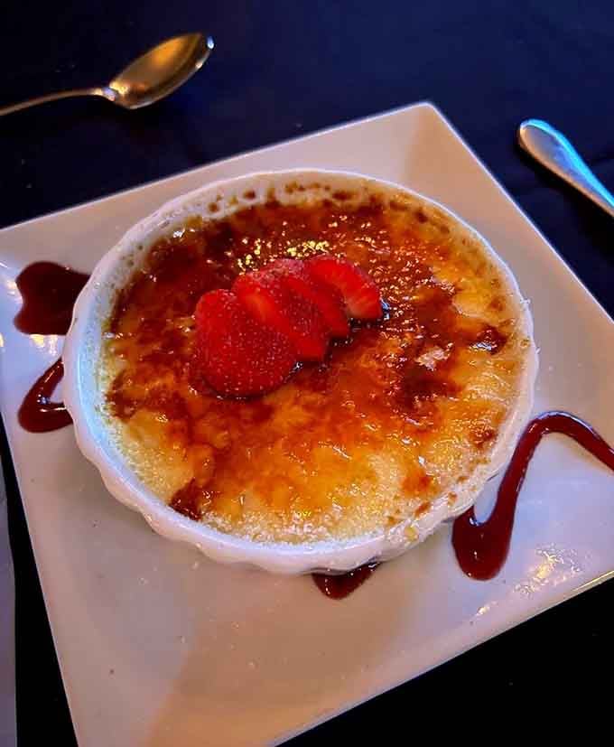 Cr&egrave;me br&ucirc;l&eacute;e with that satisfying crack, strawberry garnish, and chocolate drizzle for the Instagram-worthy finish.
