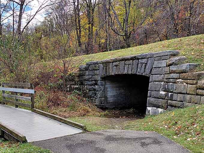 This charming stone underpass adds character to your lakeside stroll, proving even functional architecture can be downright photogenic here.
