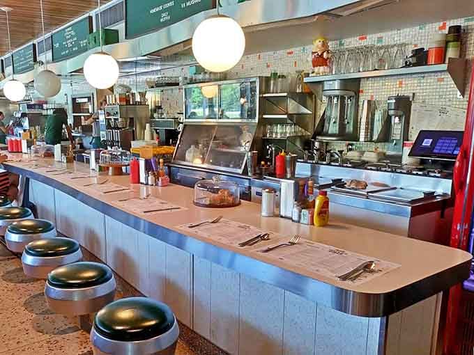The gleaming counter with swivel stools invites you to watch the kitchen ballet while sipping perfectly brewed coffee all morning.