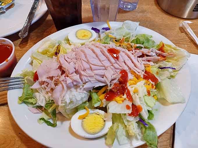 A chef salad loaded with ham, eggs, and fresh vegetables proves that even the lighter options here don't mess around.