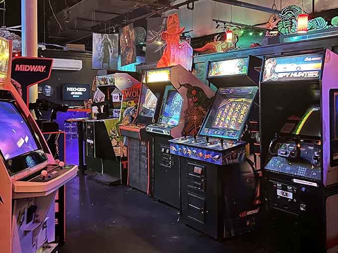 Rows of vintage cabinets stand ready like old friends, each one holding memories of quarters well spent.