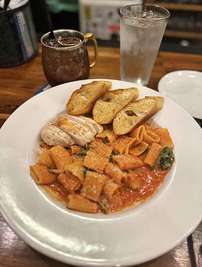 Rigatoni done right with garlic bread backup, because carbs supporting carbs is just good teamwork.