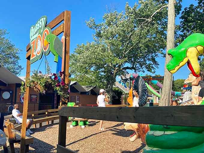 Families explore the playful zoo area, enjoying colorful animals, sunshine, and carefree summer fun together.