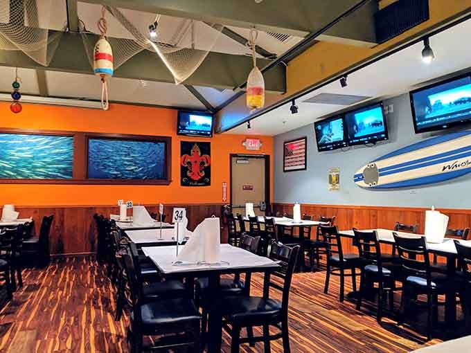 Bright orange walls and maritime decor create a space that's both energetic and inviting for your seafood feast.