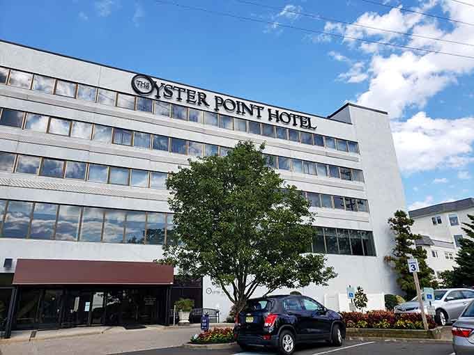 The Oyster Point Hotel rises clean and modern against blue skies, proving Red Bank embraces every architectural era.