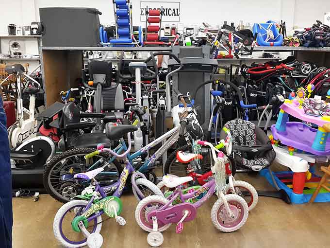 Bikes, exercise equipment, and baby gear all coexisting peacefully in one glorious corner of bargain-hunting paradise.
