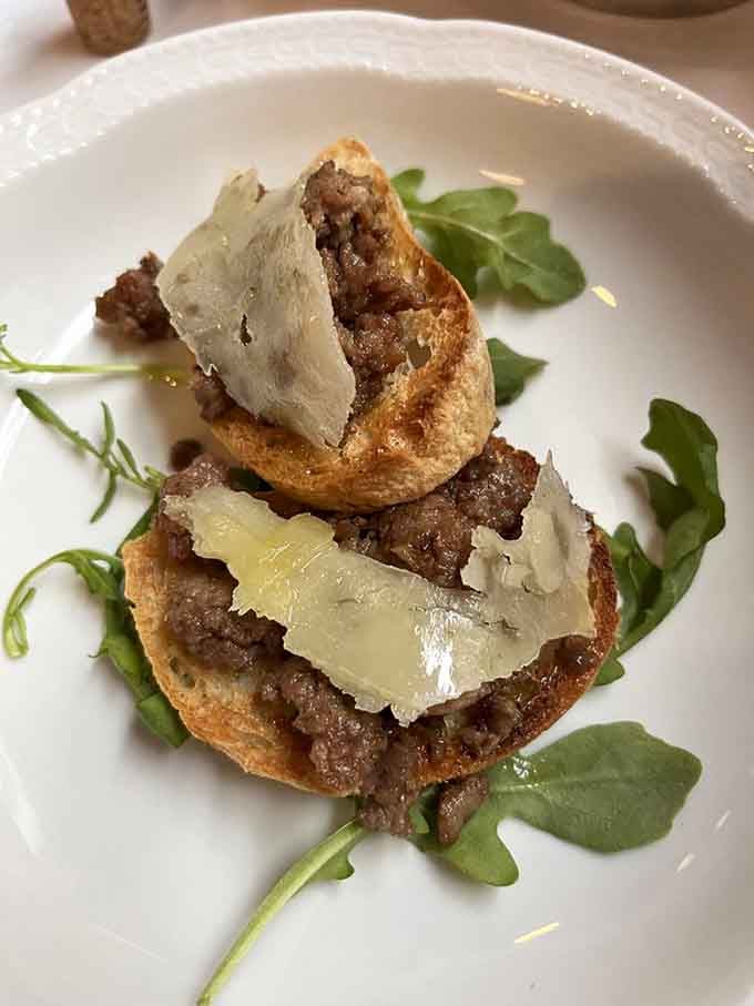 Bruschetta topped with what appears to be a savory spread and cheese, proving toast can be sophisticated when Italians are involved.