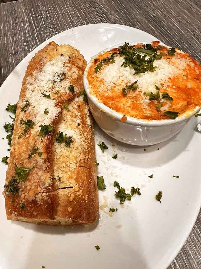 Garlic bread and seafood dip create the kind of appetizer combination that makes sharing feel like a punishment.