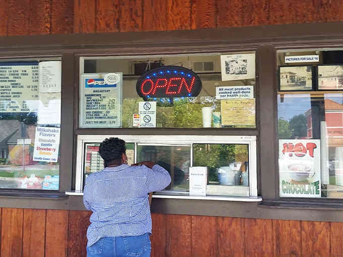 The anticipation at that window is real, where strangers bond over shared hunger and excellent life choices.