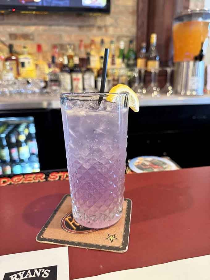 A Lavender Collins sits pretty in purple, proving cocktails can be both sophisticated and Instagram-worthy simultaneously.
