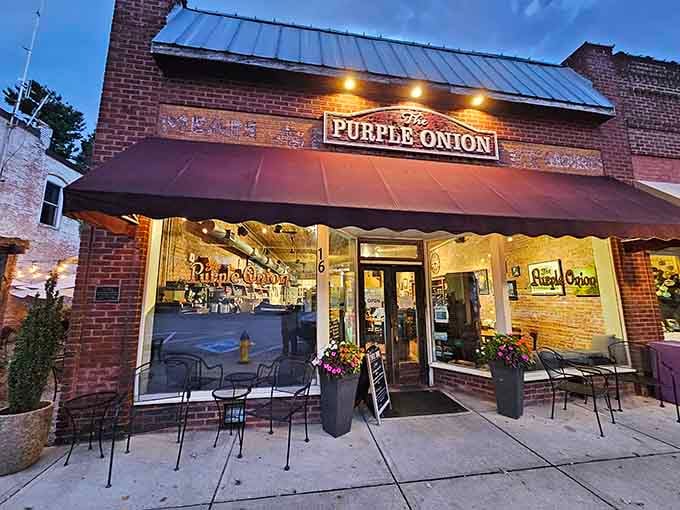 The Purple Onion glows invitingly at dusk, beckoning hungry souls with promises of comfort food and genuine hospitality.