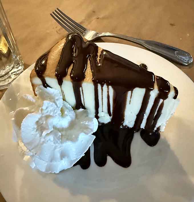 Cheesecake drizzled with chocolate, because even seafood lovers deserve a sweet finale worth remembering always.