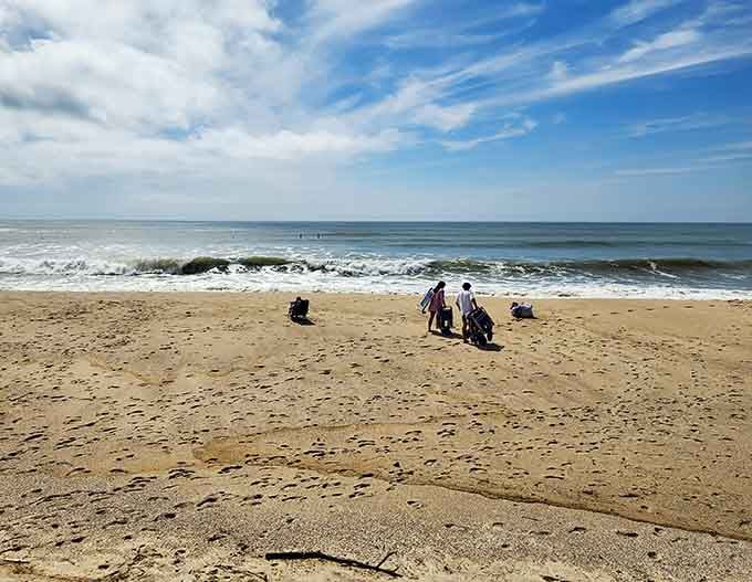 Beach blankets dot the sand like colorful confetti while families claim their perfect spots for the day.