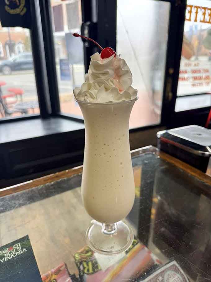 That vanilla milkshake topped with whipped cream and a cherry is basically childhood in a glass, nostalgia included.