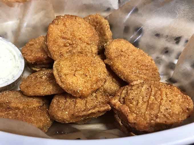 Fried pickles piled high because sometimes vegetables need a little help to become truly irresistible.