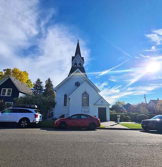A pristine white chapel catching perfect light, looking like it wandered off a New England postcard and settled here.