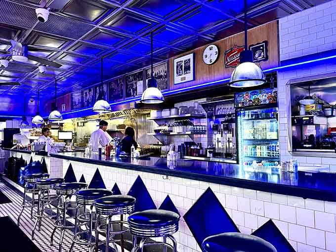 The classic diner counter with its chrome fixtures and pendant lights is where magic happens at any hour.