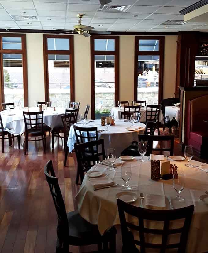 Natural light streaming through those windows onto crisp white tablecloths creates the perfect setting for a leisurely, civilized lunch experience.