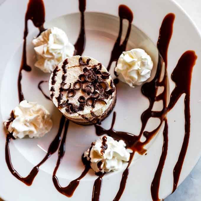 Triple chocolate mousse cake drizzled with chocolate sauce, because sometimes you need dessert after all that seafood indulgence.