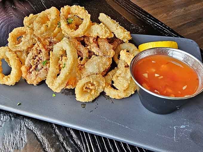 Golden-fried calamari with Thai chili sauce: sometimes the best adventures come in crispy, tender rings of deliciousness.