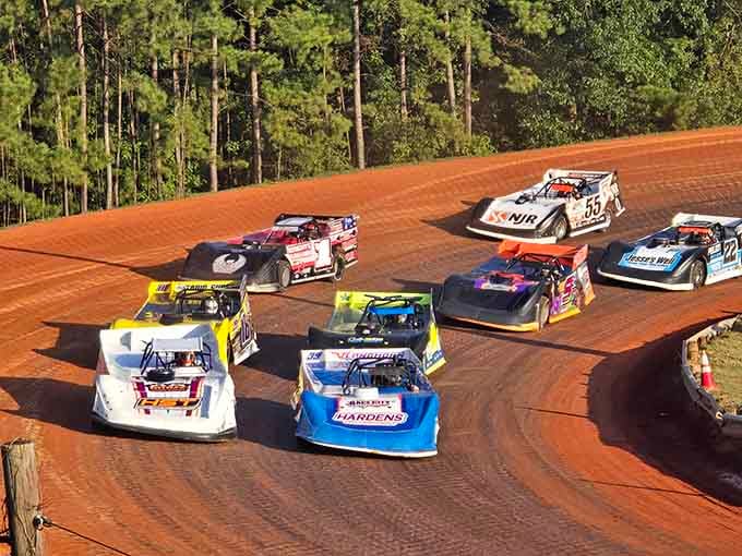 Red clay tracks and roaring engines create weekend excitement for racing fans seeking high-speed thrills.