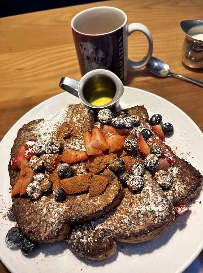 Whole wheat French toast piled high with berries and powdered sugar, breakfast decadence with a wholesome twist nobody expected.