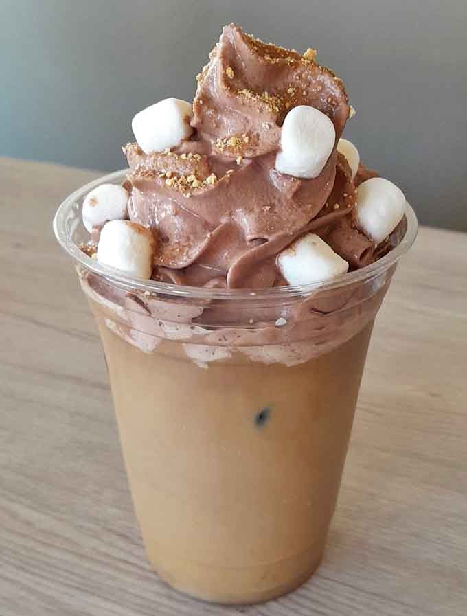 S'mores iced coffee with marshmallows and graham cracker crumbs – campfire nostalgia meets caffeine fix.