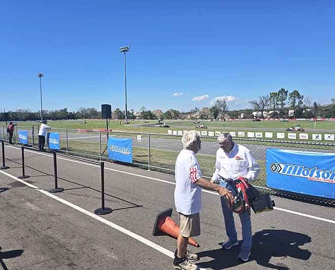 Two competitors share a trackside moment, celebrating the camaraderie that makes motorsports more than just winning and losing.
