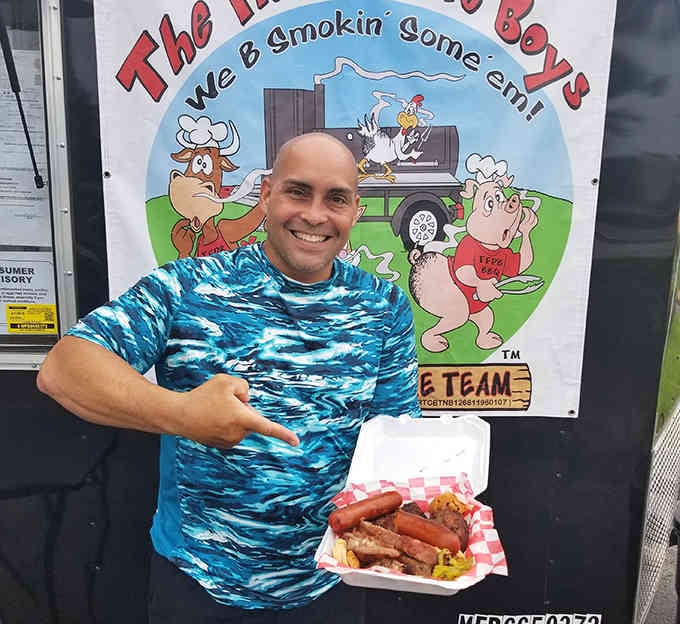 One happy customer showing off his barbecue haul, and honestly, who could blame him for that smile?