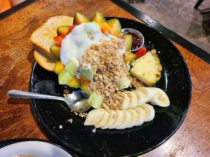 Fresh fruit, yogurt, and granola arranged like edible art for those seeking lighter morning fuel options.