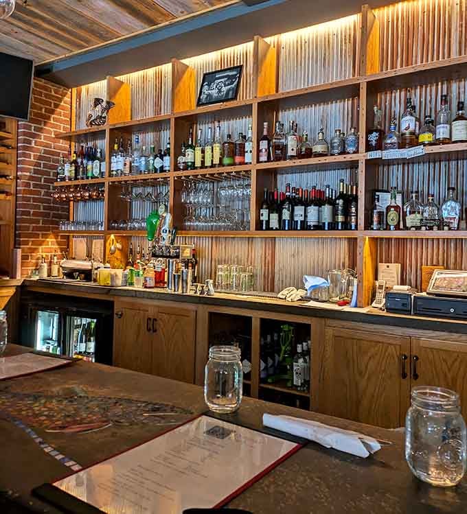 That bar setup with corrugated metal backing shows serious attention to detail and even more serious beverage options.