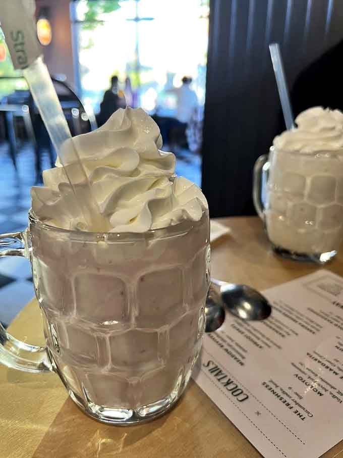 A milkshake topped with whipped cream this tall requires commitment, a long spoon, and possibly a strategic eating plan.