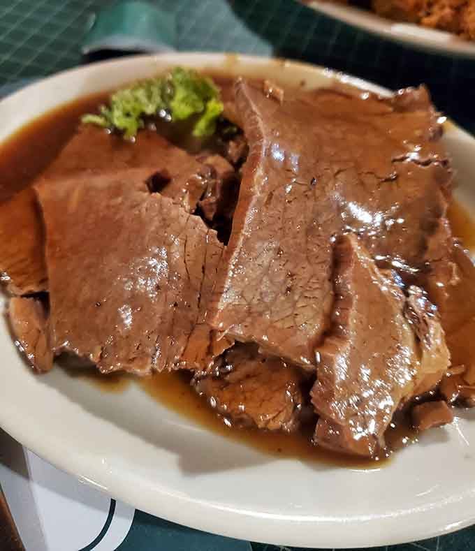Pot roast so tender it surrenders to your fork without a fight, bathed in rich gravy that demands extra bread.