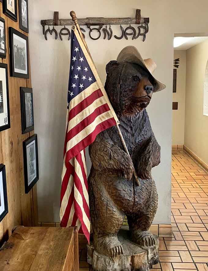 A carved bear holding an American flag welcomes you down the hallway, because why wouldn't it in a place this wonderfully quirky?