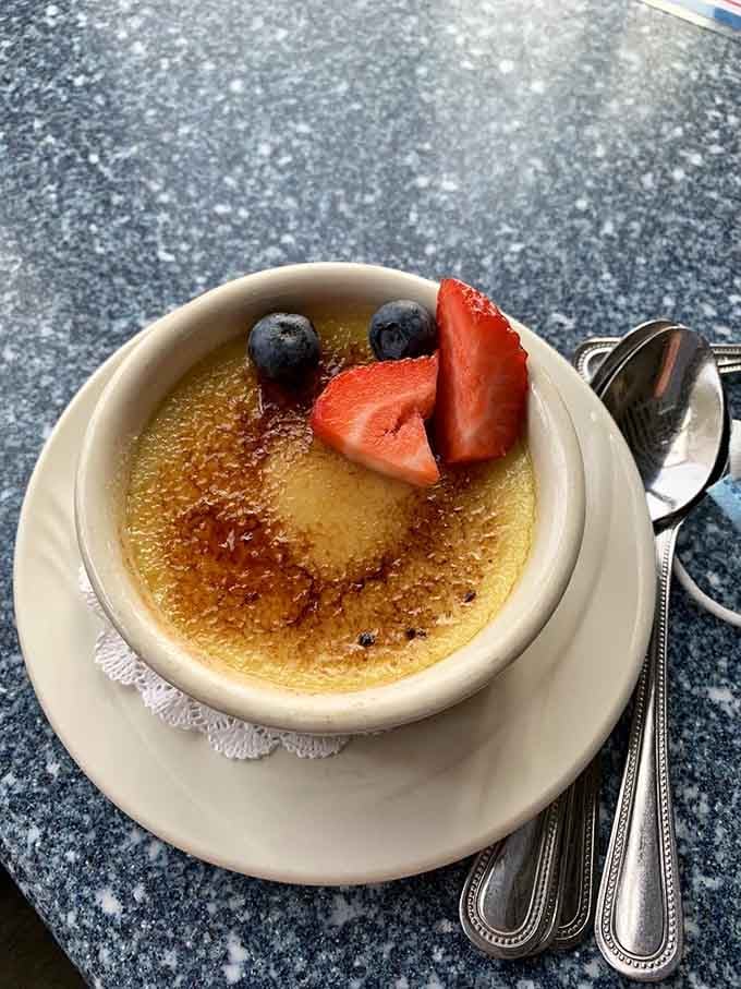 Cr&egrave;me brulee with its caramelized sugar crown and fresh berries, the sweet finale that makes you consider ordering a second round.
