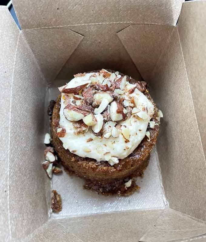 Carrot cake that looks like it's been waiting patiently in its little box just for you to discover it.