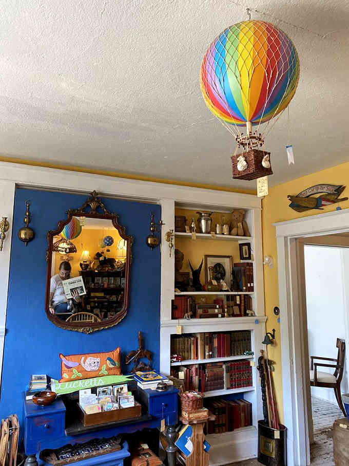 A rainbow hot air balloon floating above vintage finds, because why shouldn't shopping feel like an adventure?
