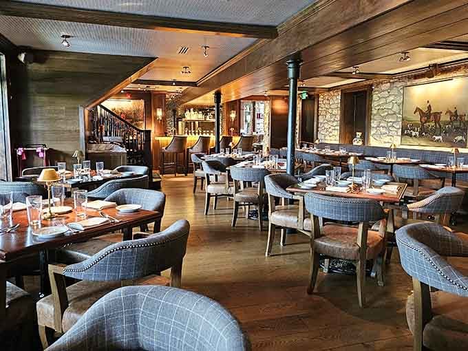 A dining room where exposed stone walls and plaid carpeting somehow work together like they've been friends for years.