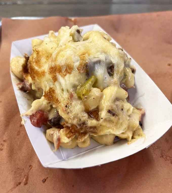 Mac and cheese topped with brisket, because someone finally asked "what if comfort food got even more comfortable?"