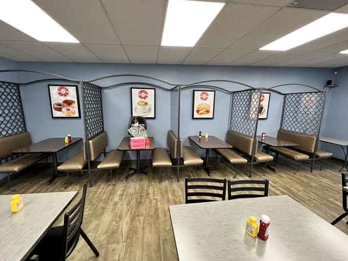 Booth seating with decorative touches and plenty of natural light streaming through those generous windows facing the parking lot.