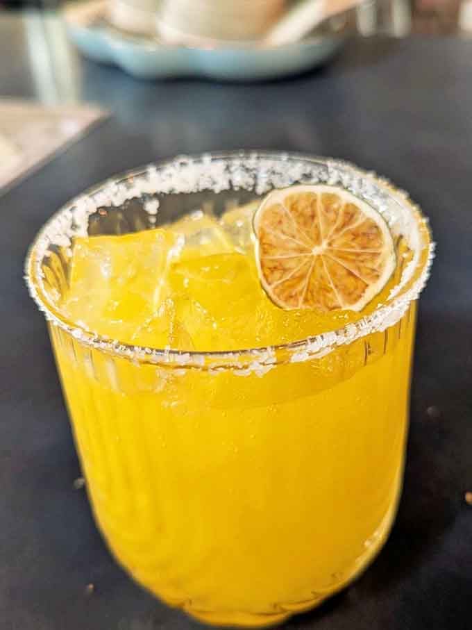 A margarita so bright and cheerful it practically radiates sunshine, perfect for washing down all that burger happiness.
